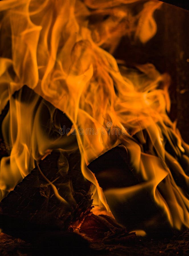 Fire Bright Burning Yellow Closeup in the Stove on a Black Background ...