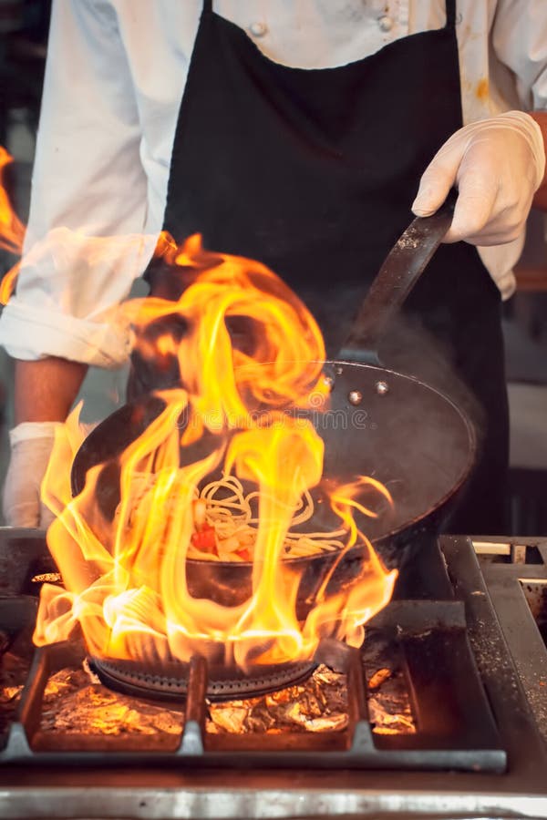 Fire Burn, Cooking on Iron Pan Stock Photo - Image of person, flame ...