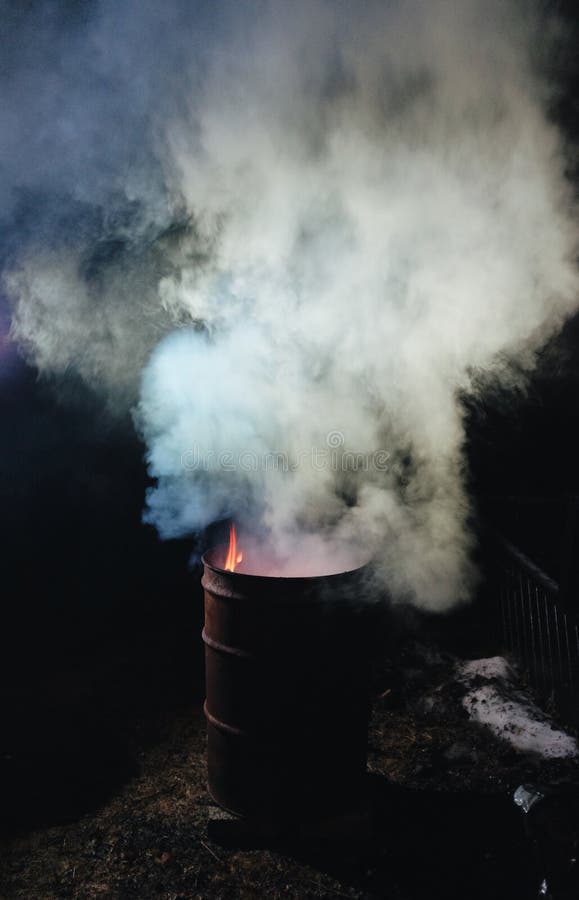 Fire Burning Inside a Metal Barrel Stock Photo - Image of dark, metal ...