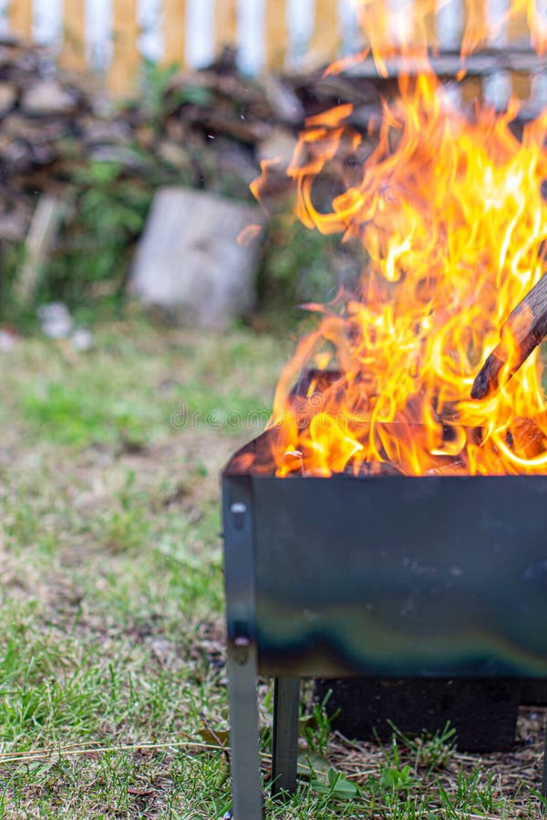 A Fire is Burning in a Metal Grill. a Large, Bright Flame of Fire at ...