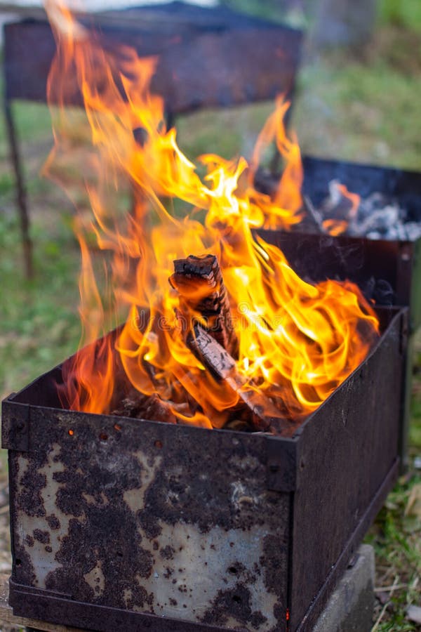 A Fire is Burning in a Metal Grill. a Large, Bright Flame of Fire at ...
