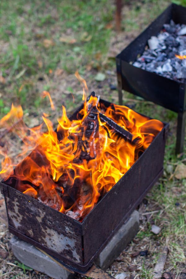 A Fire is Burning in a Metal Grill. a Large, Bright Flame of Fire at ...