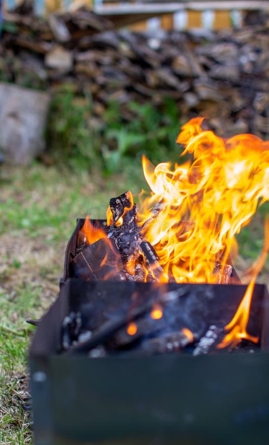 A Fire is Burning in a Metal Grill. a Large, Bright Flame of Fire at ...