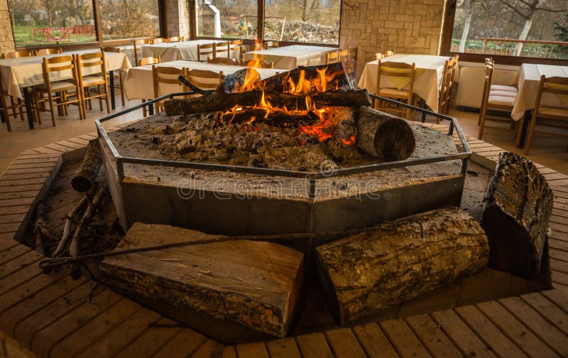 Fire Burning in Round Central Fireplace Stock Photo - Image of orange ...