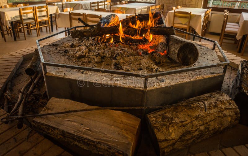 Fire Burning in Round Central Fireplace Stock Photo - Image of interior ...