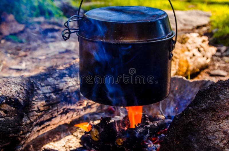 Fire Burns in the Campaign. Pot of Tea by the Fire Stock Image - Image ...