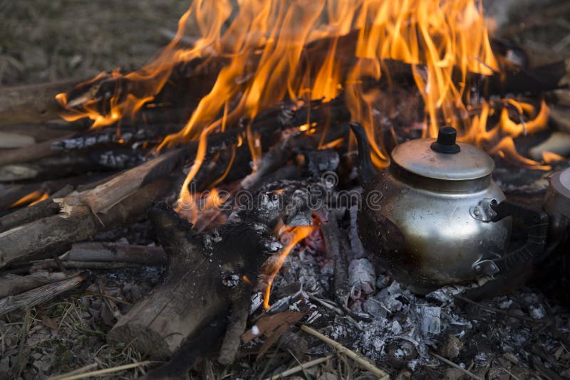 Fire Burns in the Campaign, Pot of Tea by the Fire Stock Photo - Image ...