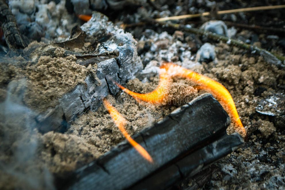 A Fire Burns in a Campfire with a Red Fire in the Background. Stock ...