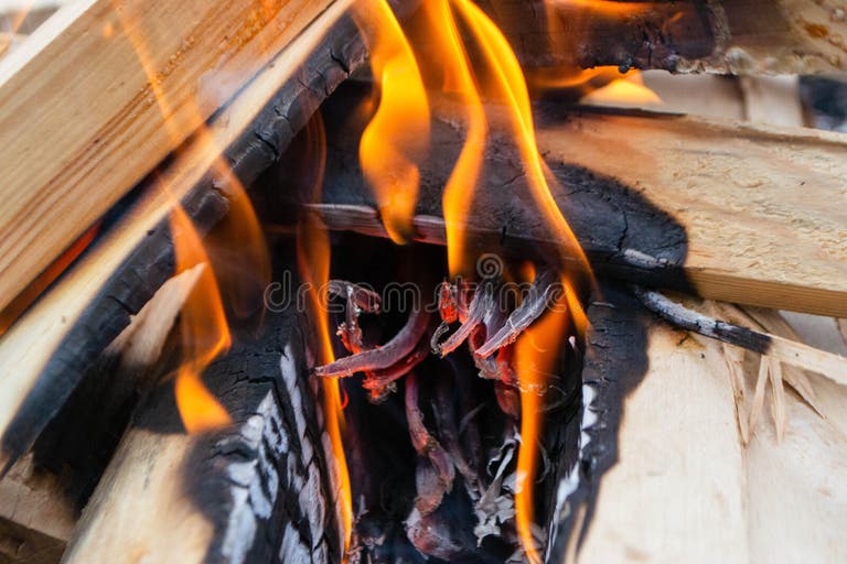 A Fire Burns in a Campfire with a Red Fire in the Background. Stock ...