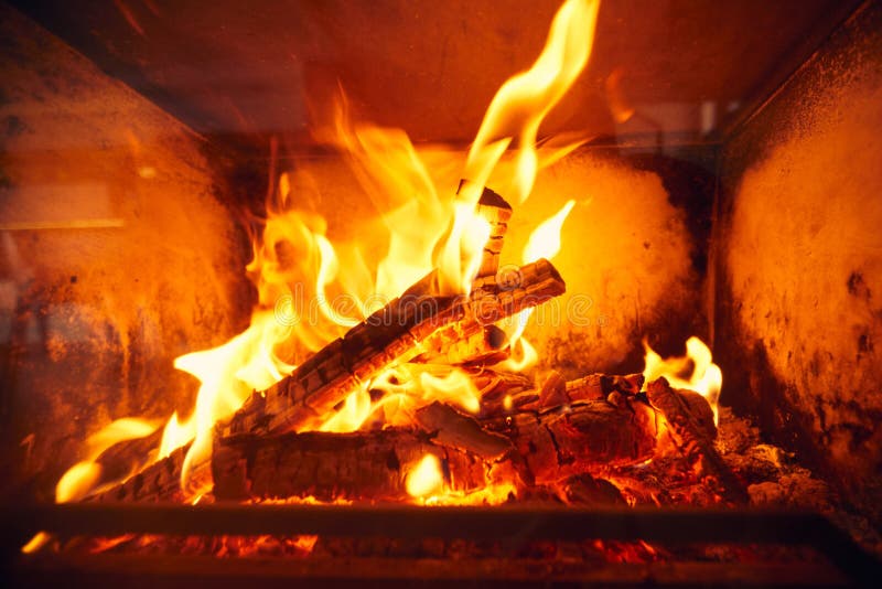 A Fire Burns in a Fireplace, Fire To Keep Warm. Logs Burning in a ...