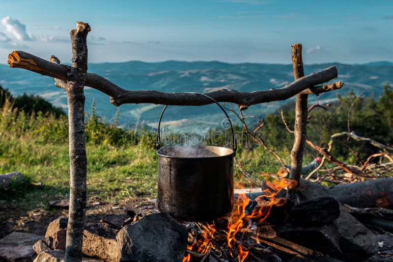 On the Fire Cauldron. Preparing Food at the Campsite. View of the ...