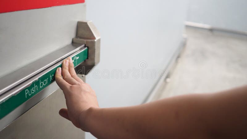 Fire Door Handle of Fire Exit for Emergency Evacuation.Hand is Push the ...