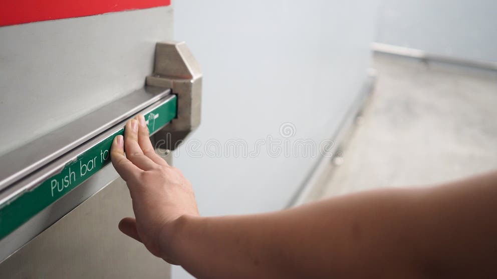 Fire Door Handle of Fire Exit for Emergency Evacuation.Hand is Push the ...