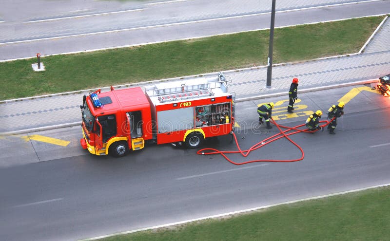 Fire Drill with Four Man Who Fight with the Fire Stock Image - Image of ...