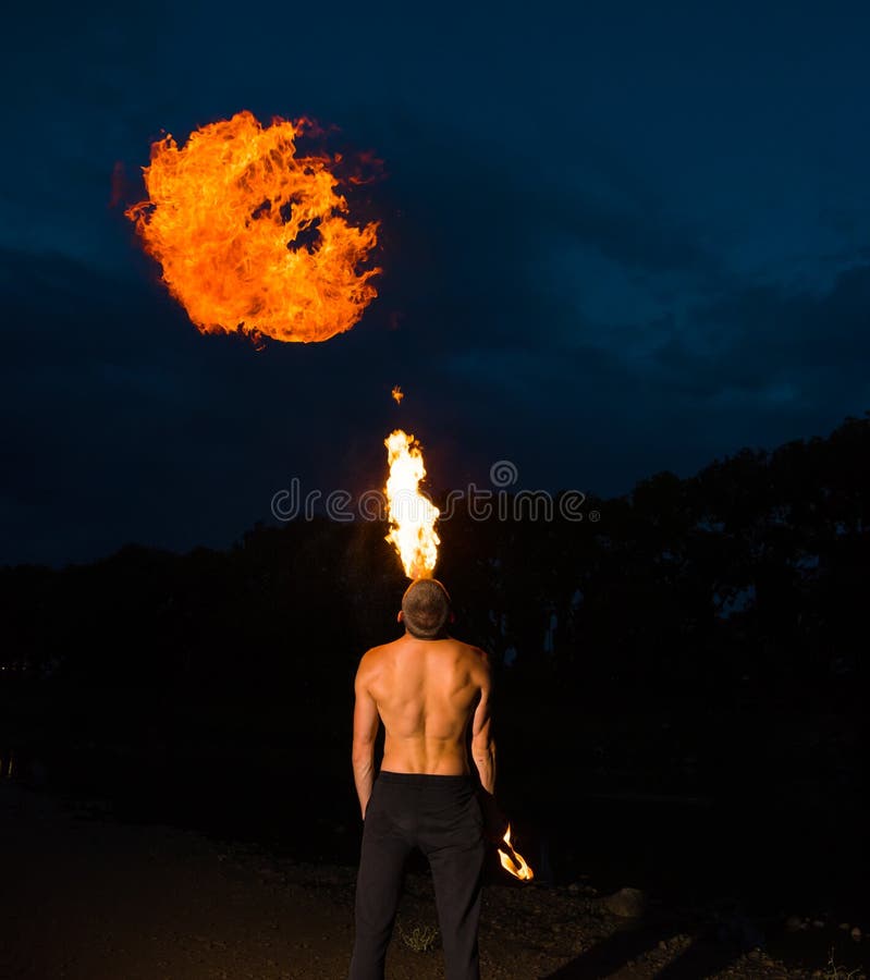 Fire-eater Blowing a Large Flame from His Mouth Stock Photo - Image of ...