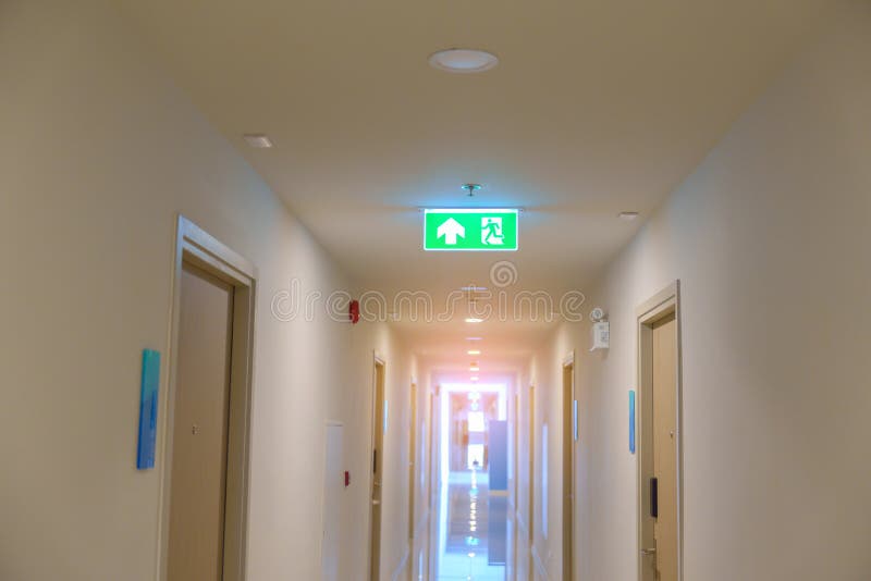 Fire Emergency Exit Sign on the Wall Background Inside Building. Safety ...