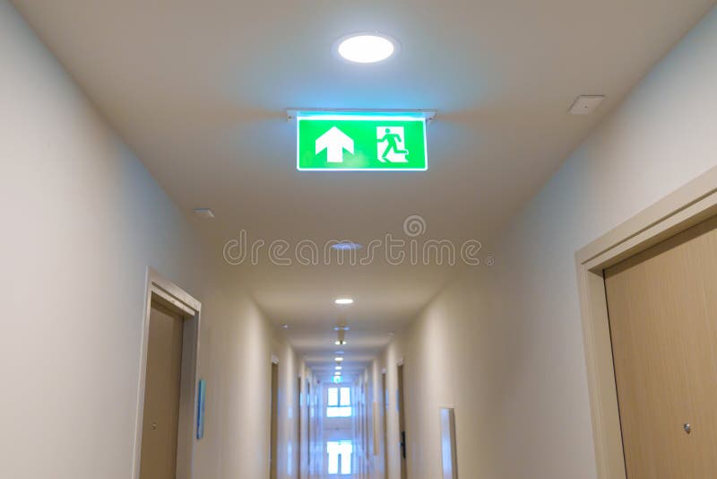 Fire Emergency Exit Sign on the Wall Background Inside Building. Safety ...