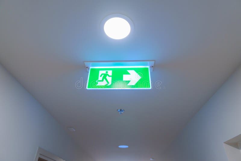 Fire Emergency Exit Sign on the Wall Background Inside Building. Safety ...