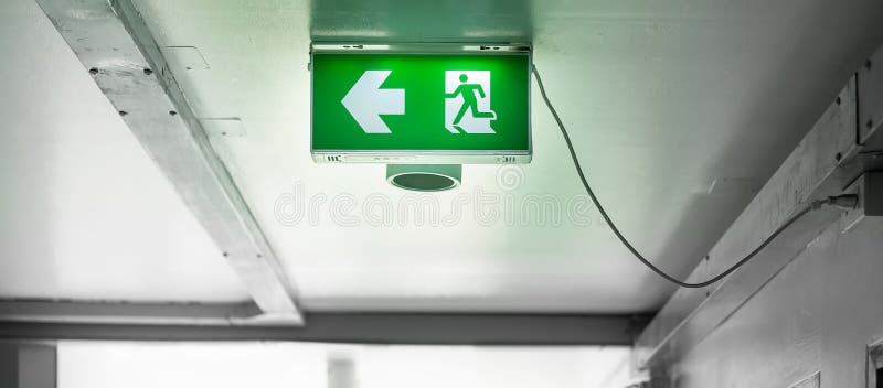 Fire Emergency Exit Sign on the Wall Background Inside Building. Safety ...