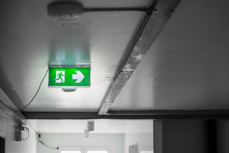 Fire Emergency Exit Sign on the Wall Background Inside Building. Safety ...