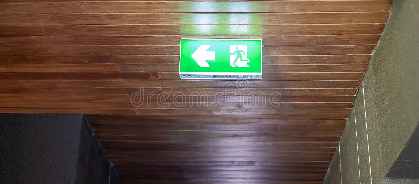 Fire Emergency Exit Sign on the Wall Background Inside Building. Safety ...
