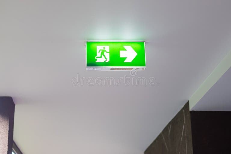 Fire Emergency Exit Sign on the Wall Background Inside Building. Safety ...