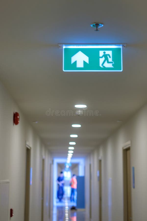 Fire Emergency Exit Sign on the Wall Background Inside Building. Safety ...