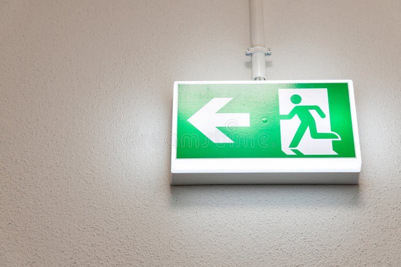 Fire Emergency Exit Sign on the Wall Background Inside Building. Safety ...