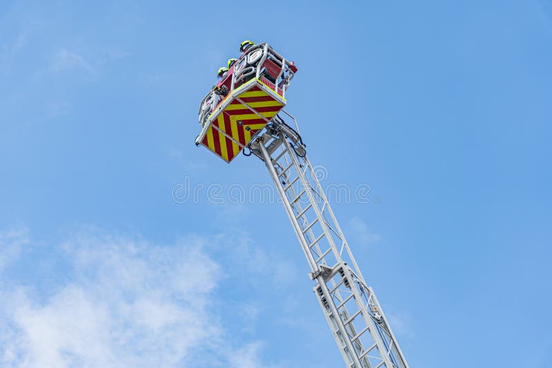 Fire Engine with Extended Ladder, Firefighter in Protective Gear ...