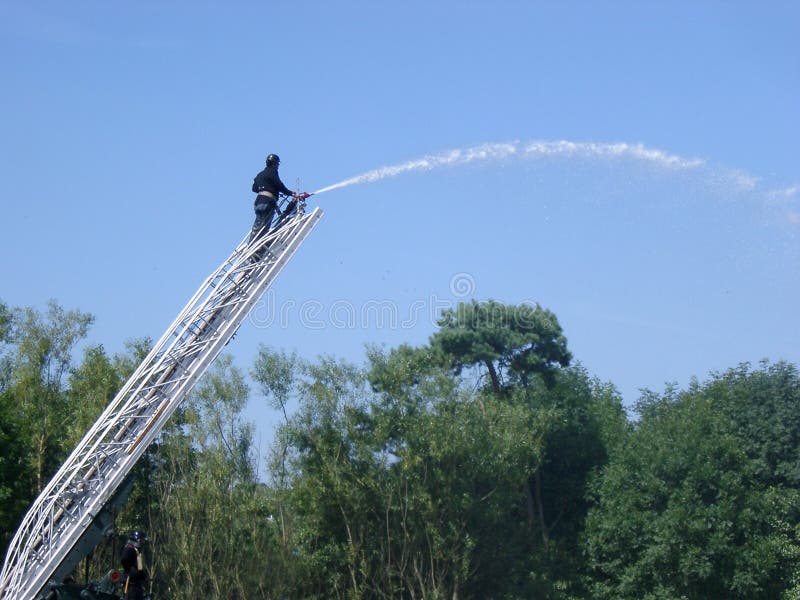 A Fire Engine Ladder, Fireman and Water from a Hose Editorial Stock ...
