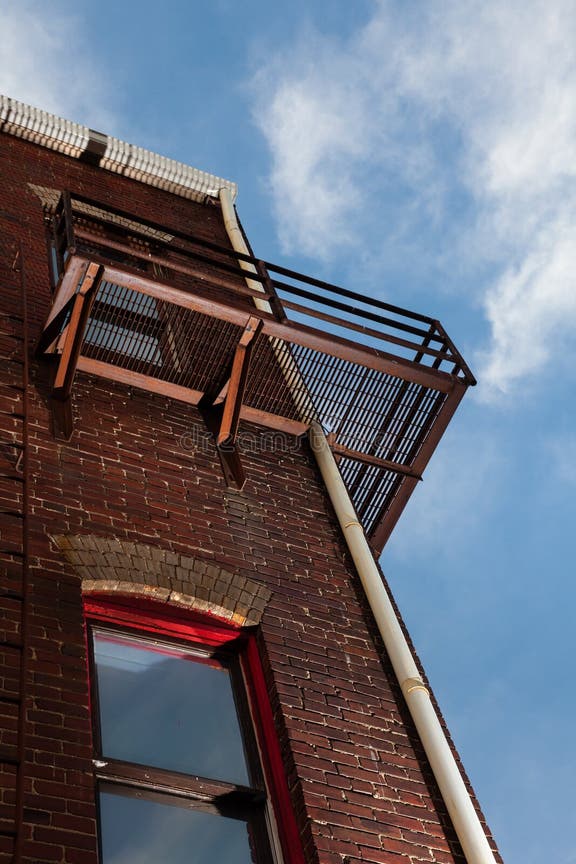 Fire Escape on Brick Building from Below Stock Photo - Image of ...