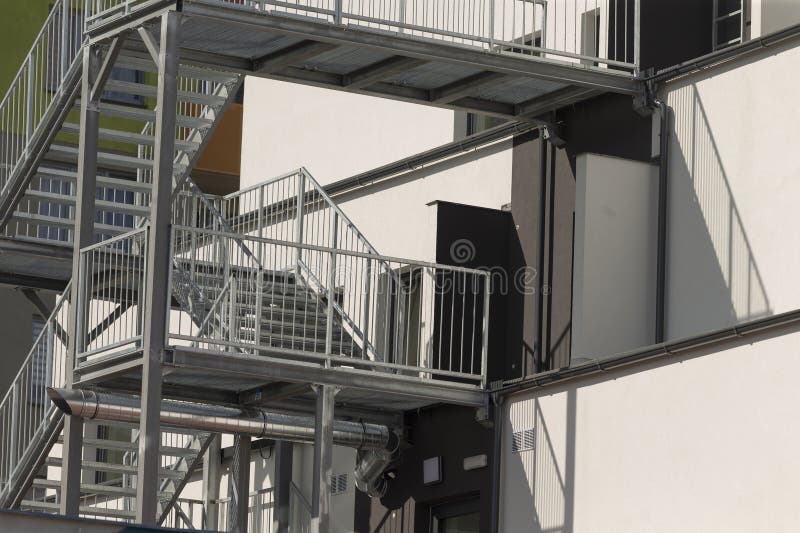 A Fire Escape is Securely Attached To the Side of a Building Structure ...