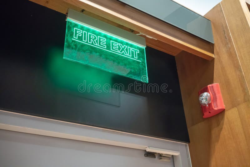 Fire Exit Sign with Green Lighting Infront of Door Stock Photo - Image ...