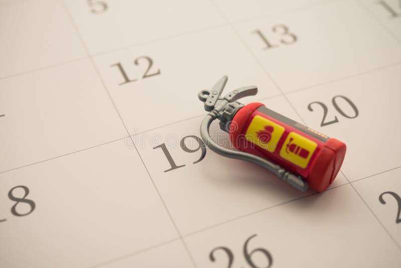 Fire Extinguisher on Calendar Background with Copy Space. Stock Image ...