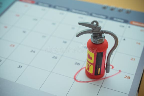 Fire Extinguisher on Calendar Background with Copy Space. Stock Image ...