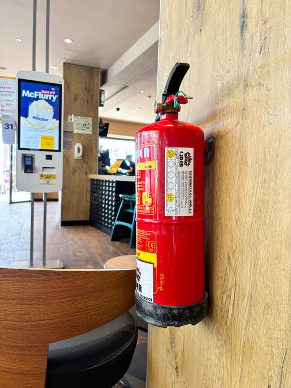 Fire Extinguisher Mounted on Wall in Modern Cafe Setting, Emphasizing ...