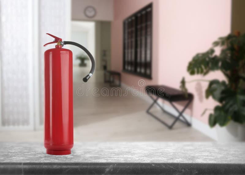 Fire Extinguisher on Stone Table in Office Corridor. Space for Text ...