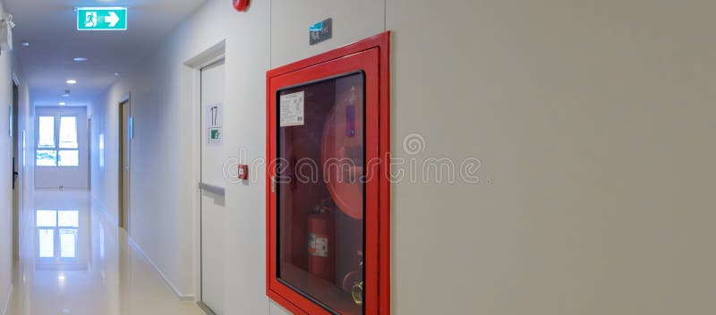 Fire Extinguisher System on the Wall with Fire Exit Door Sign for ...