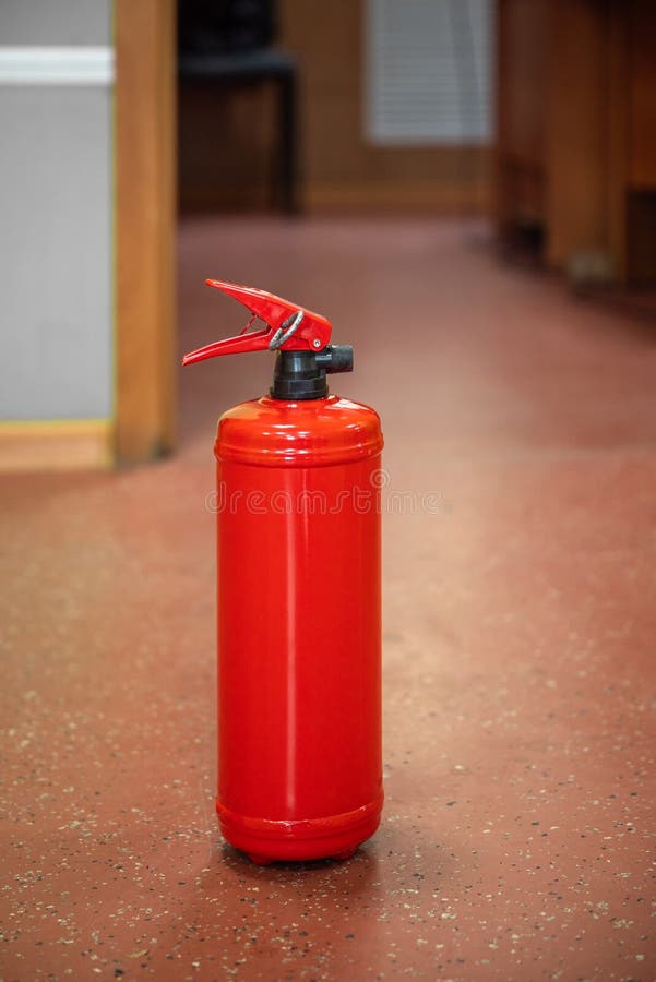 Fire Extinguisher in the Office Against the Background of a Fire ...