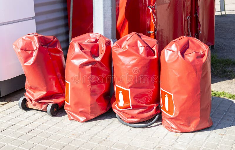 Fire Extinguishers in Protective Covers Stock Photo - Image of handle ...