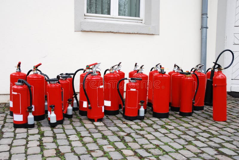A Row Of Fire Extinguishers Stock Photo - Image of chemical ...
