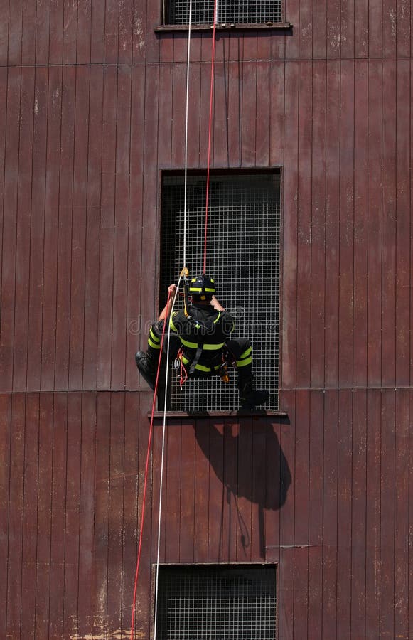 Fire Fighter Climbing the Building Using the Double Cord Technique with ...