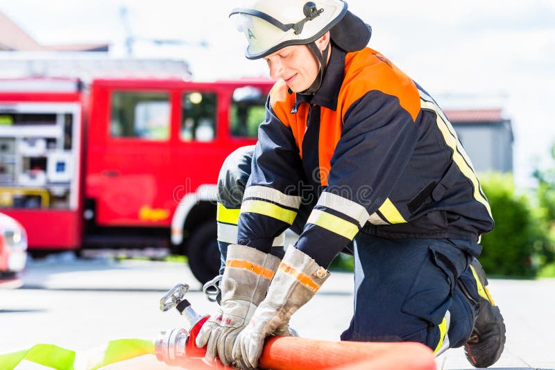 Fire Fighter Connecting Hoses Stock Image - Image of caucasian, people ...
