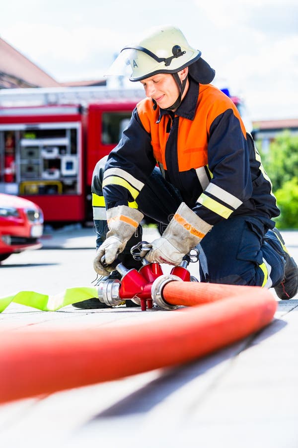 Fire Fighter Connecting Hoses Stock Image - Image of caucasian, people ...