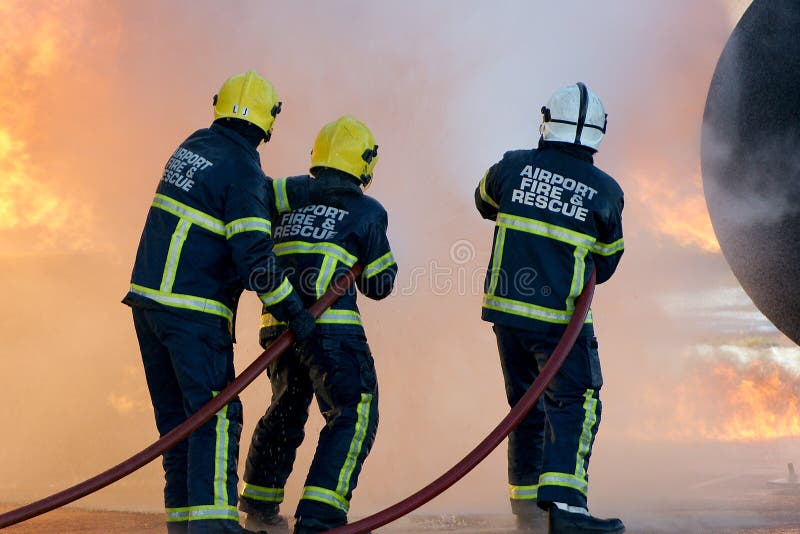 Fire-fighter fighting fire editorial stock photo. Image of heat - 46794748