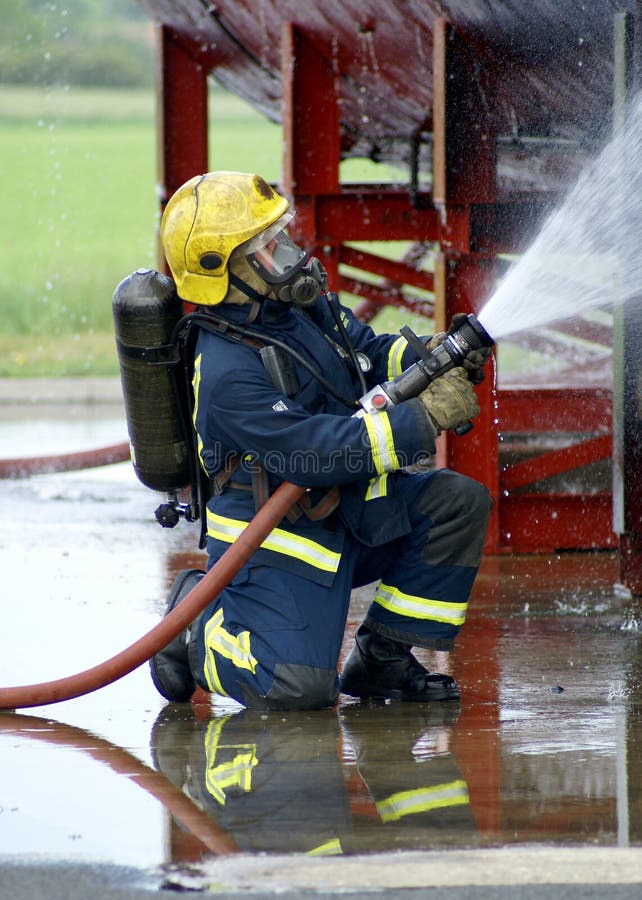 Fire-fighter with hose editorial stock image. Image of inferno - 46796544