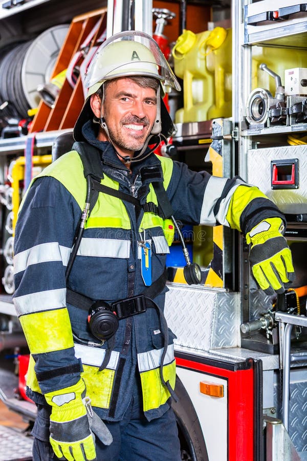 Fire Fighter in Protective Clothes Leaning at Fire Engine Stock Image ...