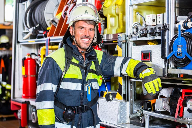 Fire Fighter in Protective Clothes Leaning at Fire Engine Stock Photo ...