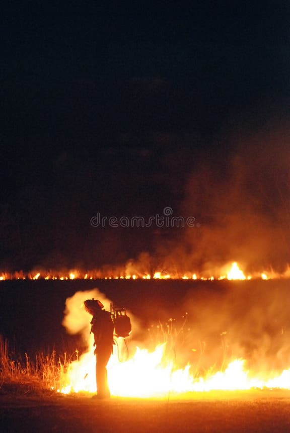 A Fire Fighter Safely Setting a Controlled Burn Stock Photo - Image of ...