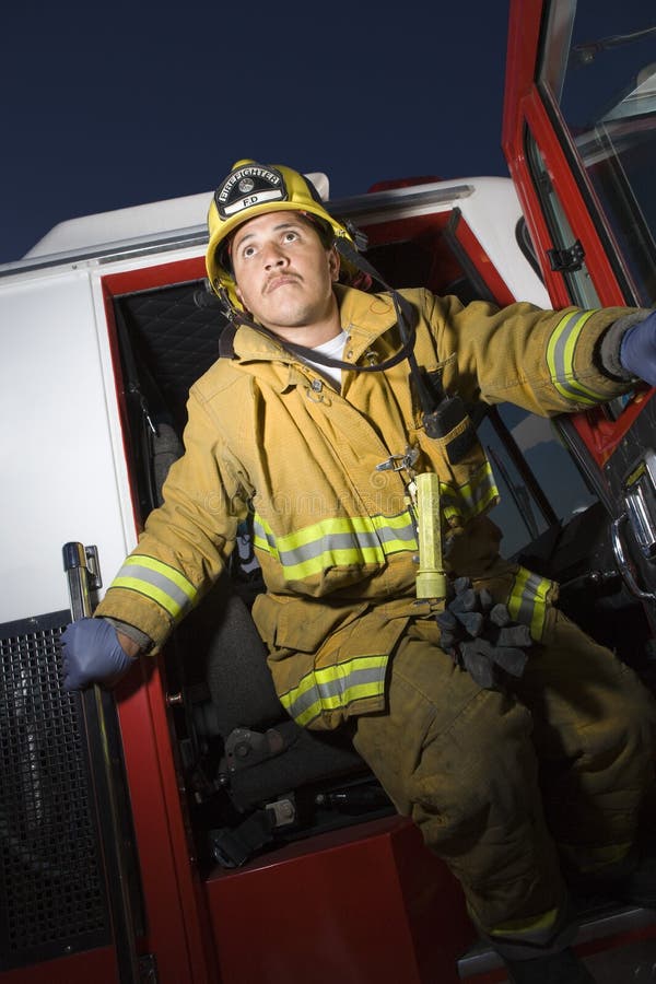 Fire Fighter Standing in Front of Fire Engine Stock Image - Image of ...